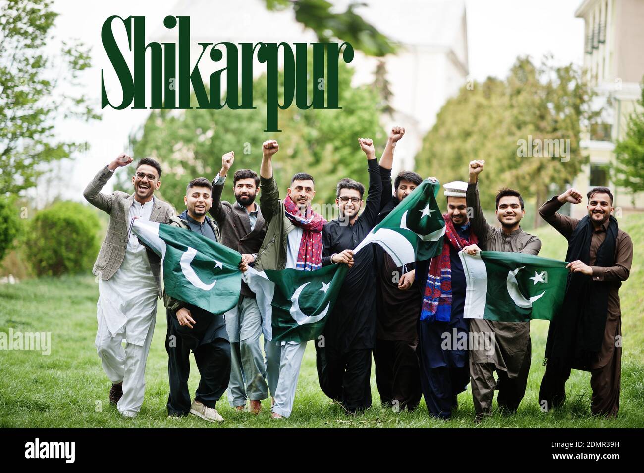 Shikarpur city. Group of pakistani man wearing traditional clothes with national flags. Biggest ...