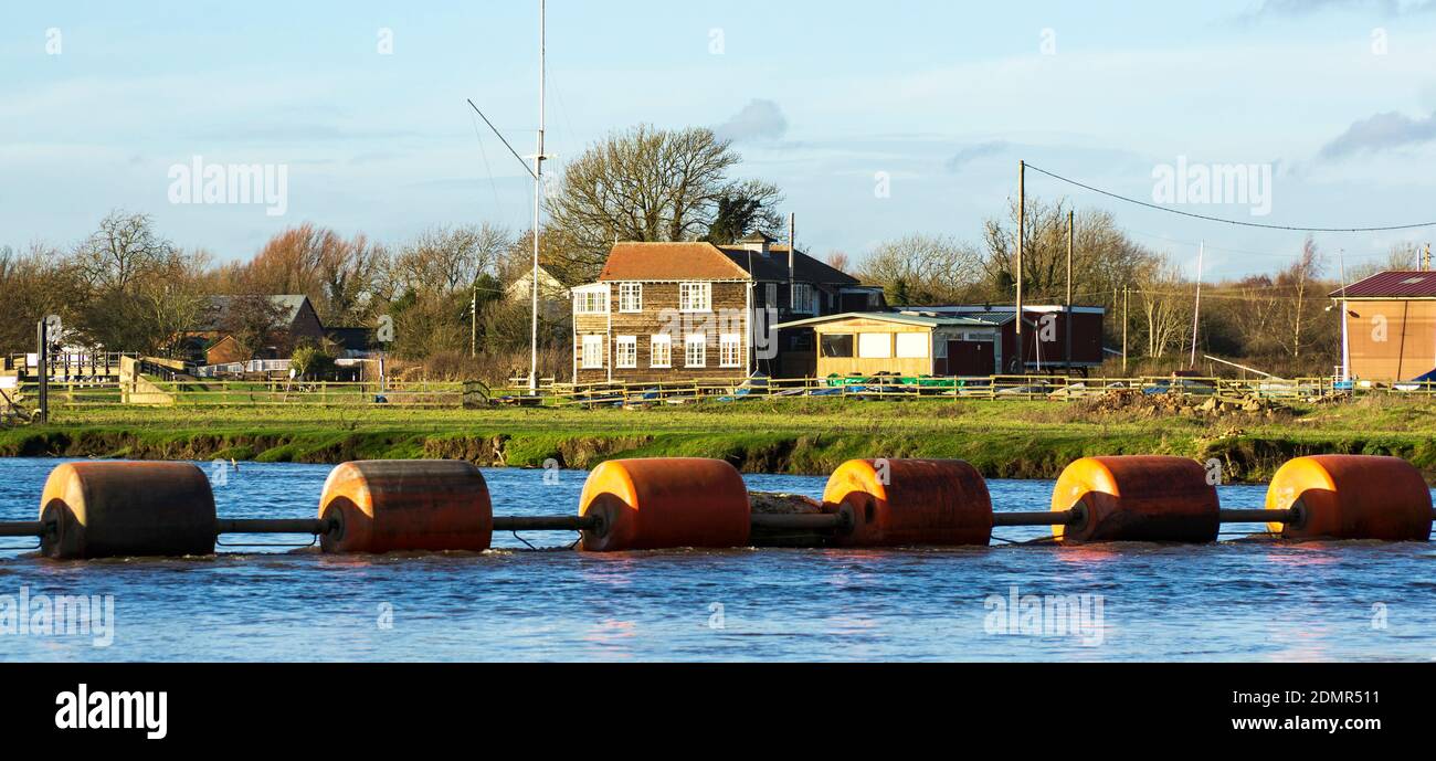 Orange safety boom across a river Stock Photo - Alamy