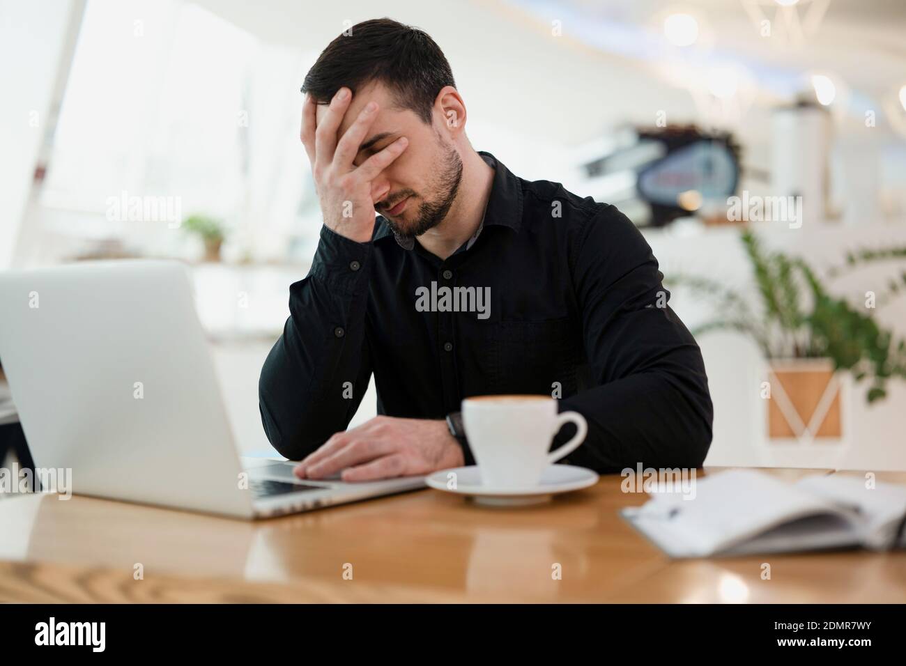 Freelancer man facepalming. Remote work from coffeehouse. Young ...
