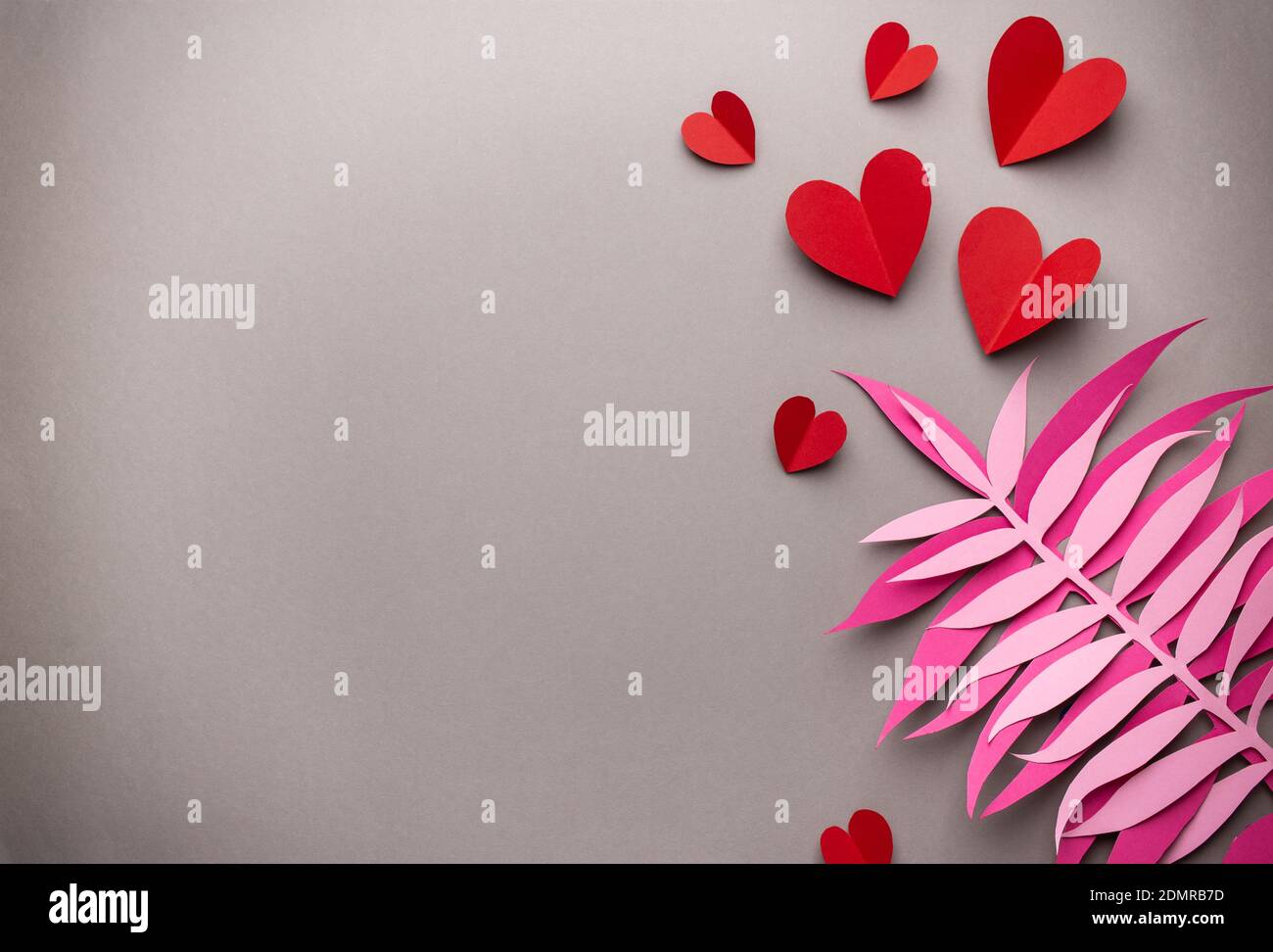 Red hearts cut from paper on pink background, paper craft origami style ...
