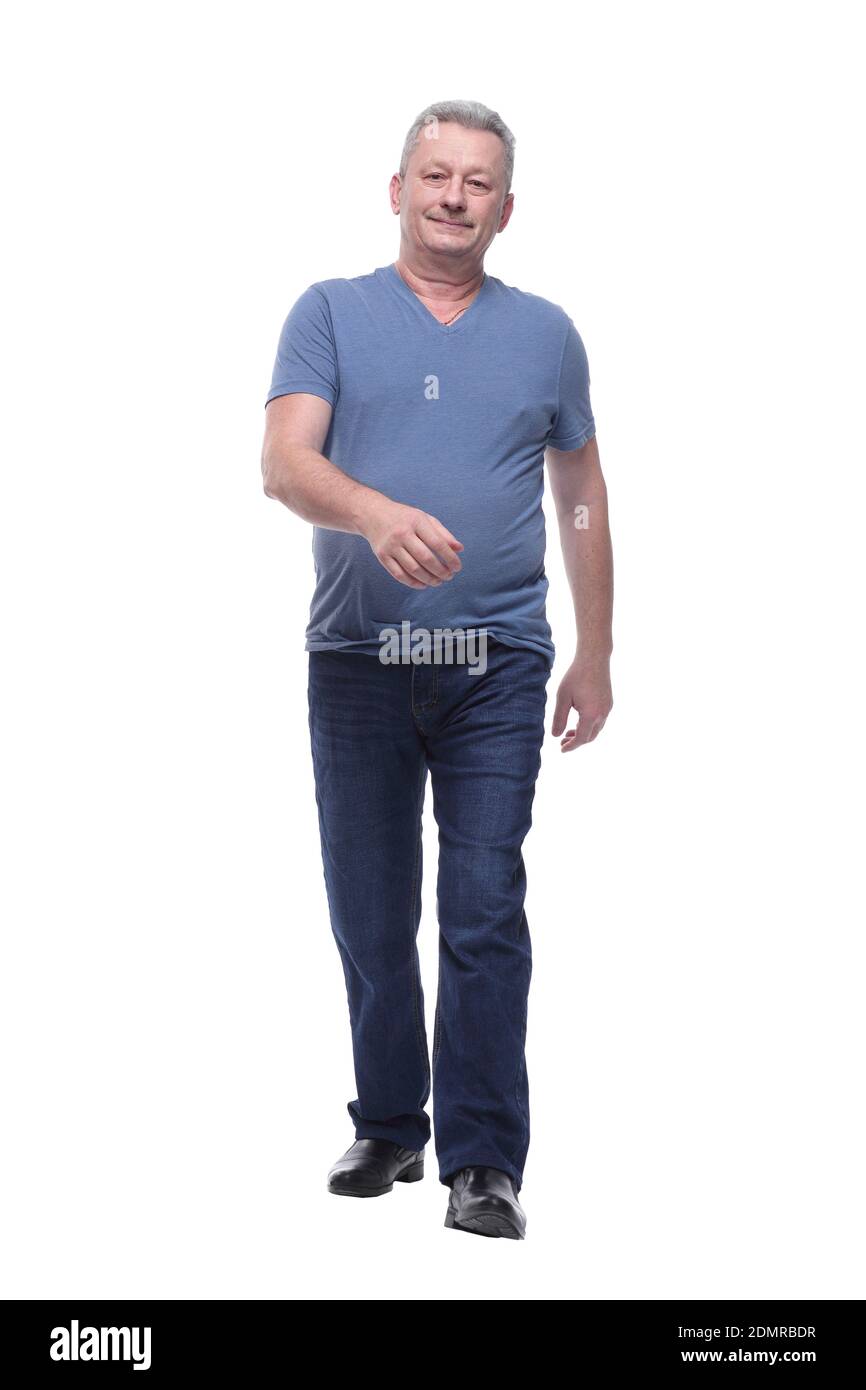 Full length picture of a casual serious man walking towards the camera ...