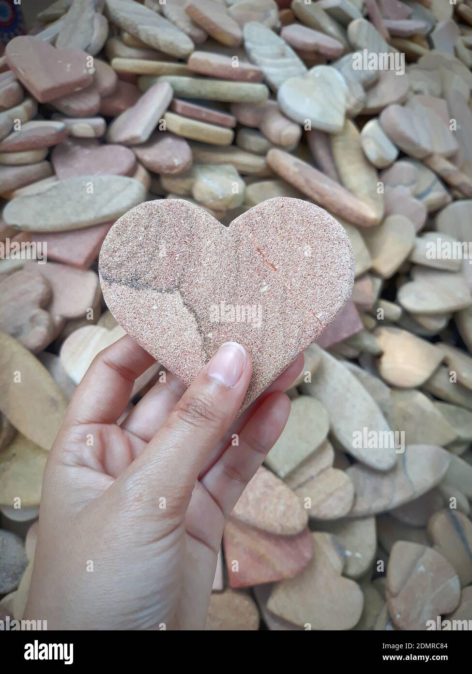 Hand holding stone heart hi-res stock photography and images - Alamy