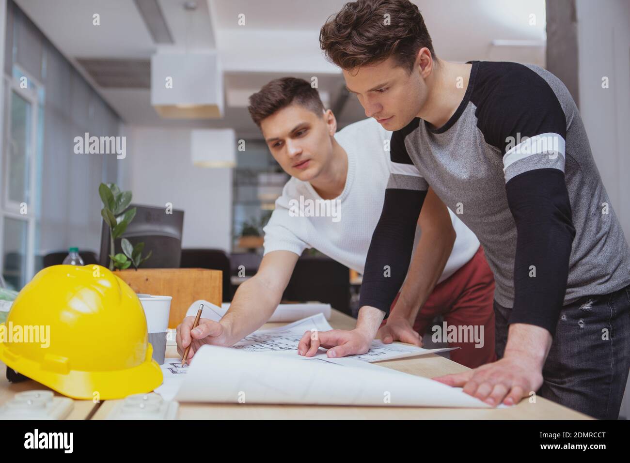 Architects at work, engineering concept. Two young male architects ...