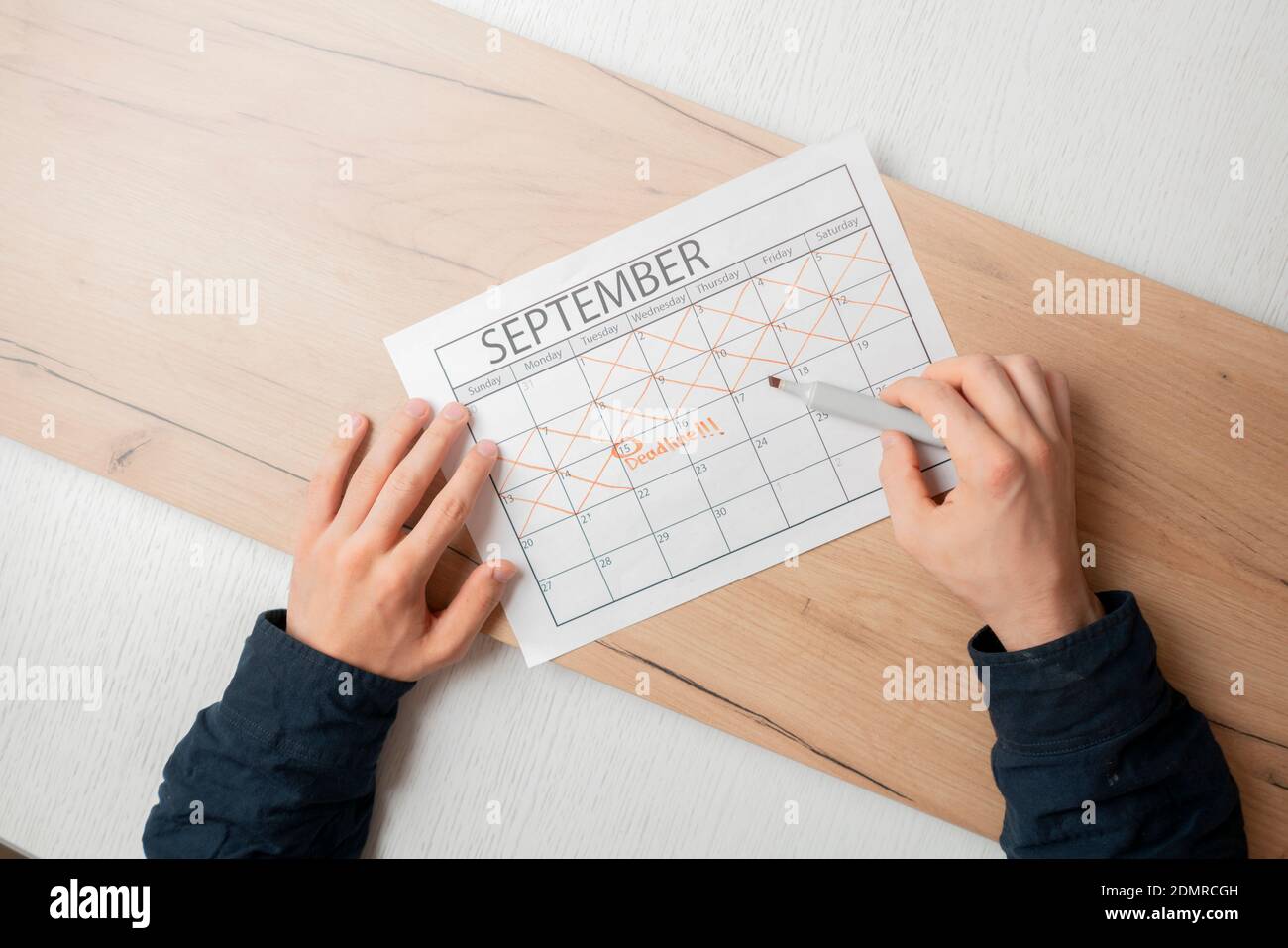 person make a cross on the date in calendar, take notes Stock Photo - Alamy