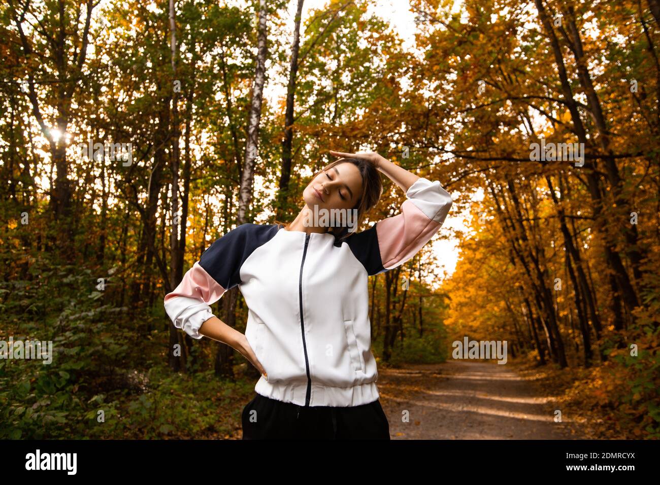 Young sporty woman stretching in forest. Healthy lifestyle concept ...