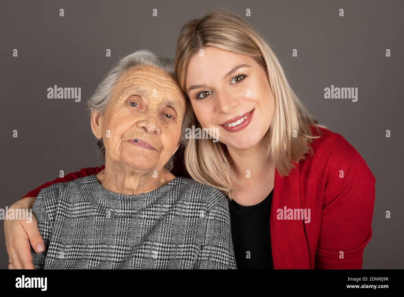Portrait of two beautiful women of different generation, looking to the ...