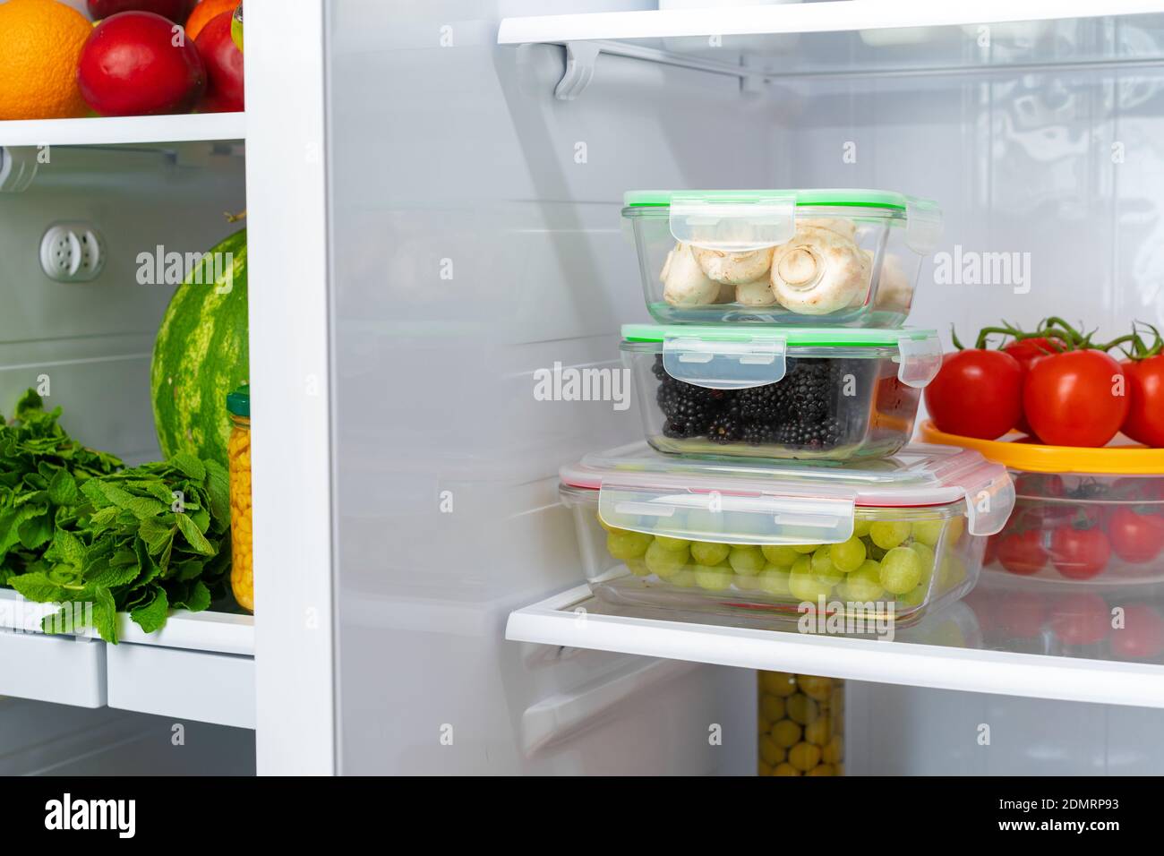 Storage containers with fresh food in a fridge Stock Photo - Alamy