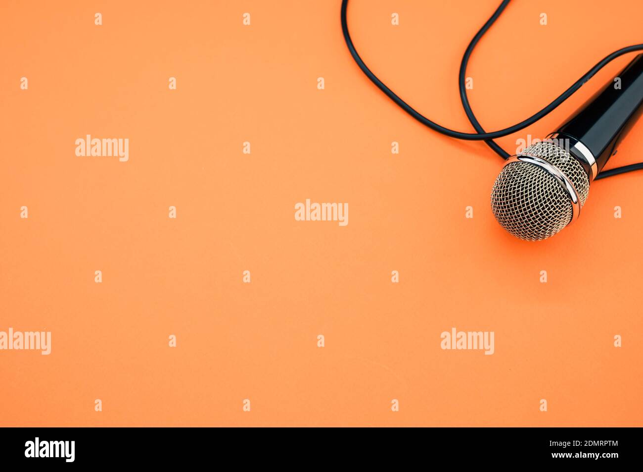 A top view of a microphone on an orange surface Stock Photo - Alamy