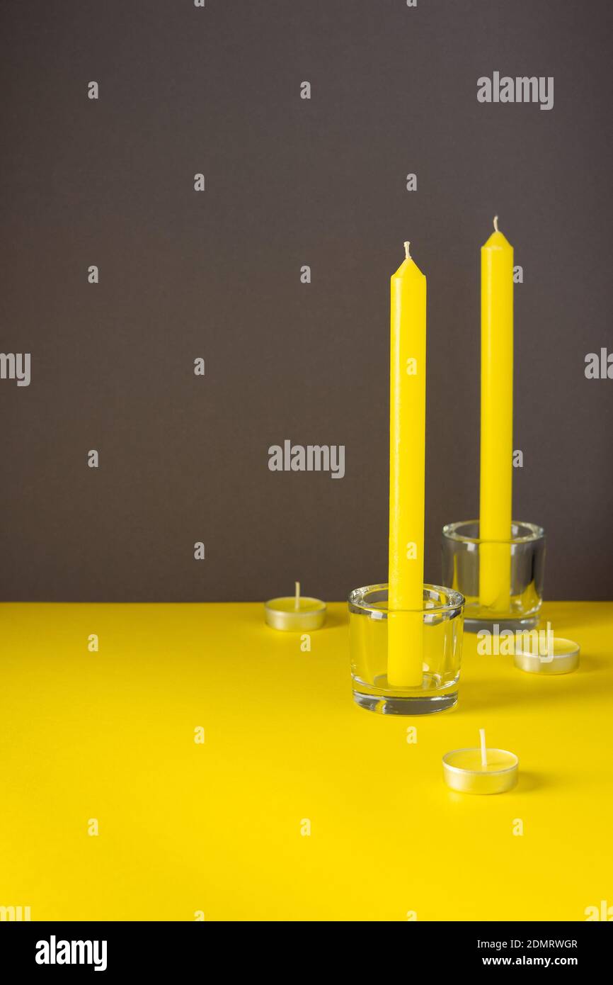 Yellow candles in a glass candlesticks, trendy colors of the year ...