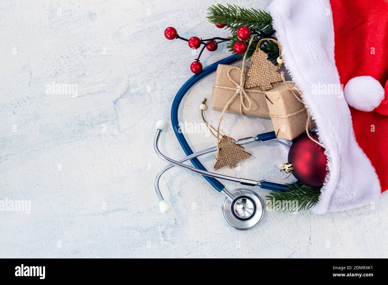 Stethoscope with branches of Christmas tree, Christmas gifts and red ...