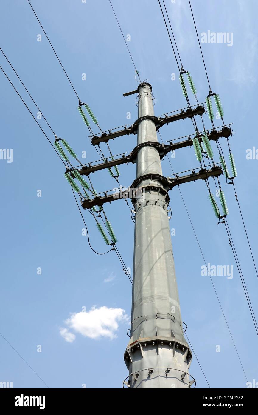 High-voltage strong power line metal prop painted grey with many wires ...