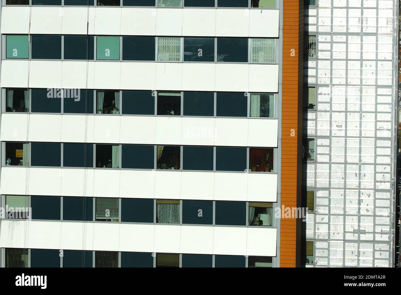 Workmen remove the cladding from the facade of a block of flats in ...