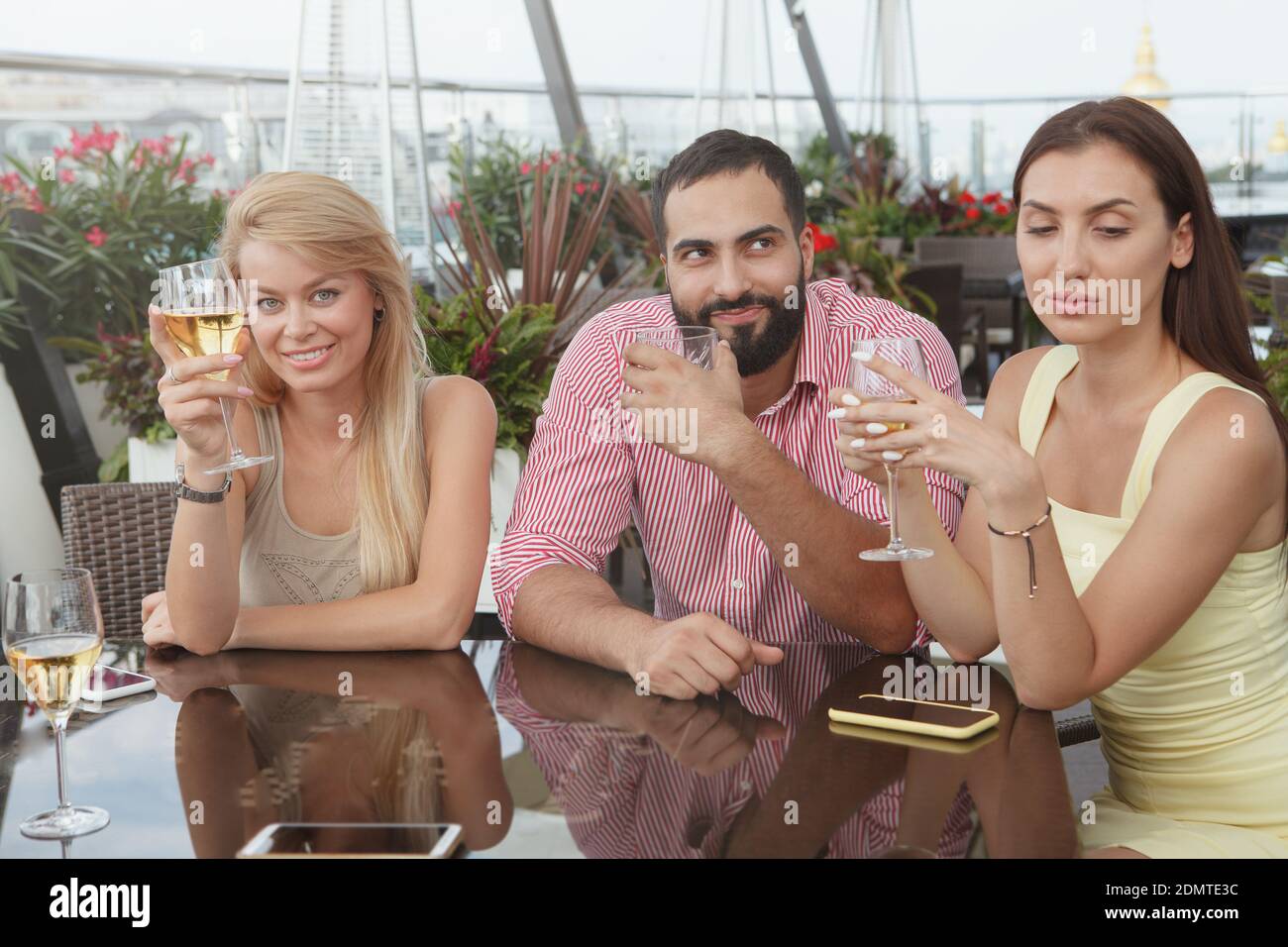 Cheerful friends enjoying drinking together at rooftop bar Stock Photo ...
