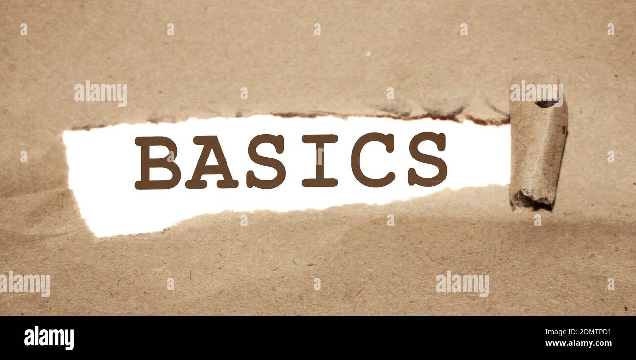 The word Basics appearing behind torn brown paper. Education concept ...