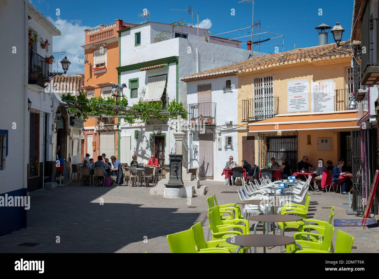 Denia, Costa Blanca, Alicante, Spain. People sitting outside bars and restaurants in the ...
