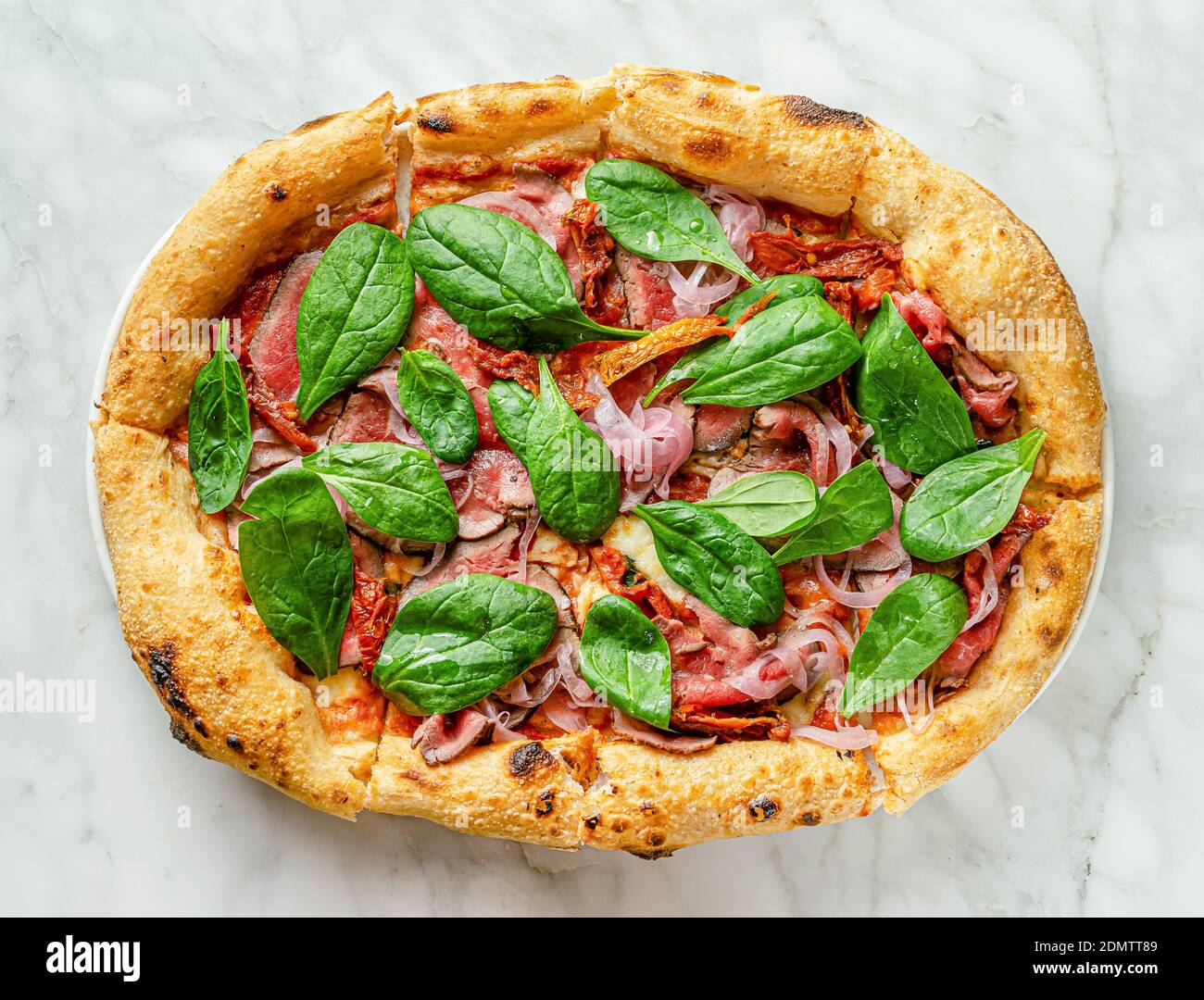 Traditional Roman pizza with roast beef, sundried tomatoes, pickled ...