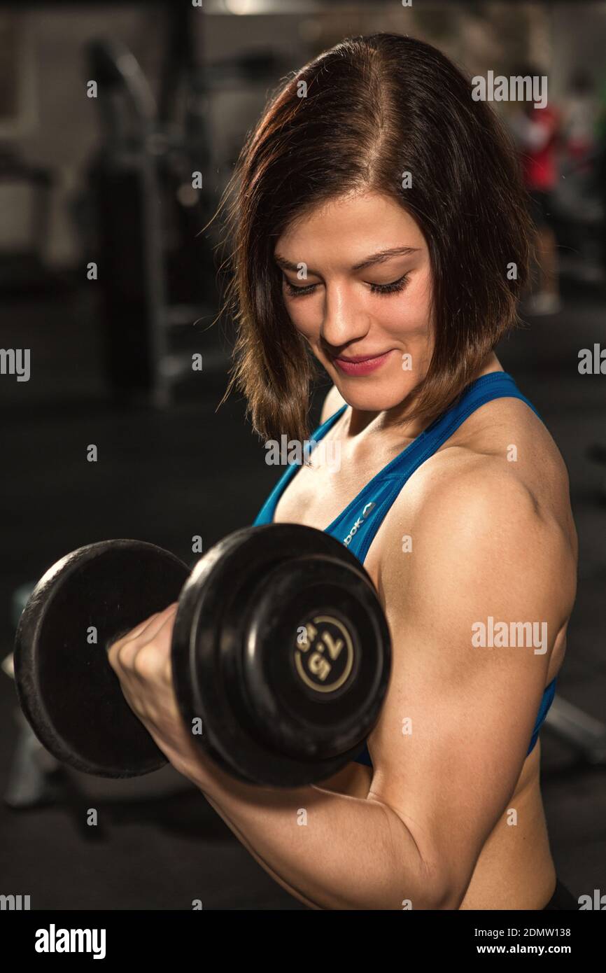 Beautiful muscular sportswoman pumping arms hi-res stock photography ...