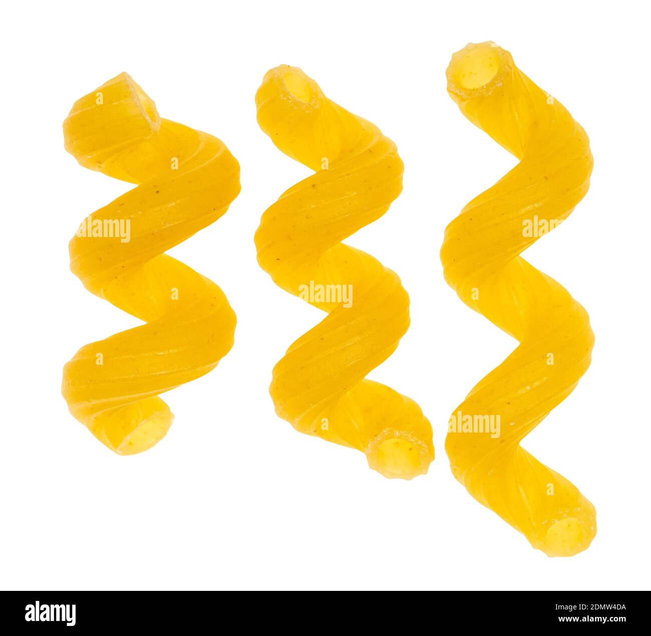 three single dried Cavatappi (variety of italian short pasta) close up ...