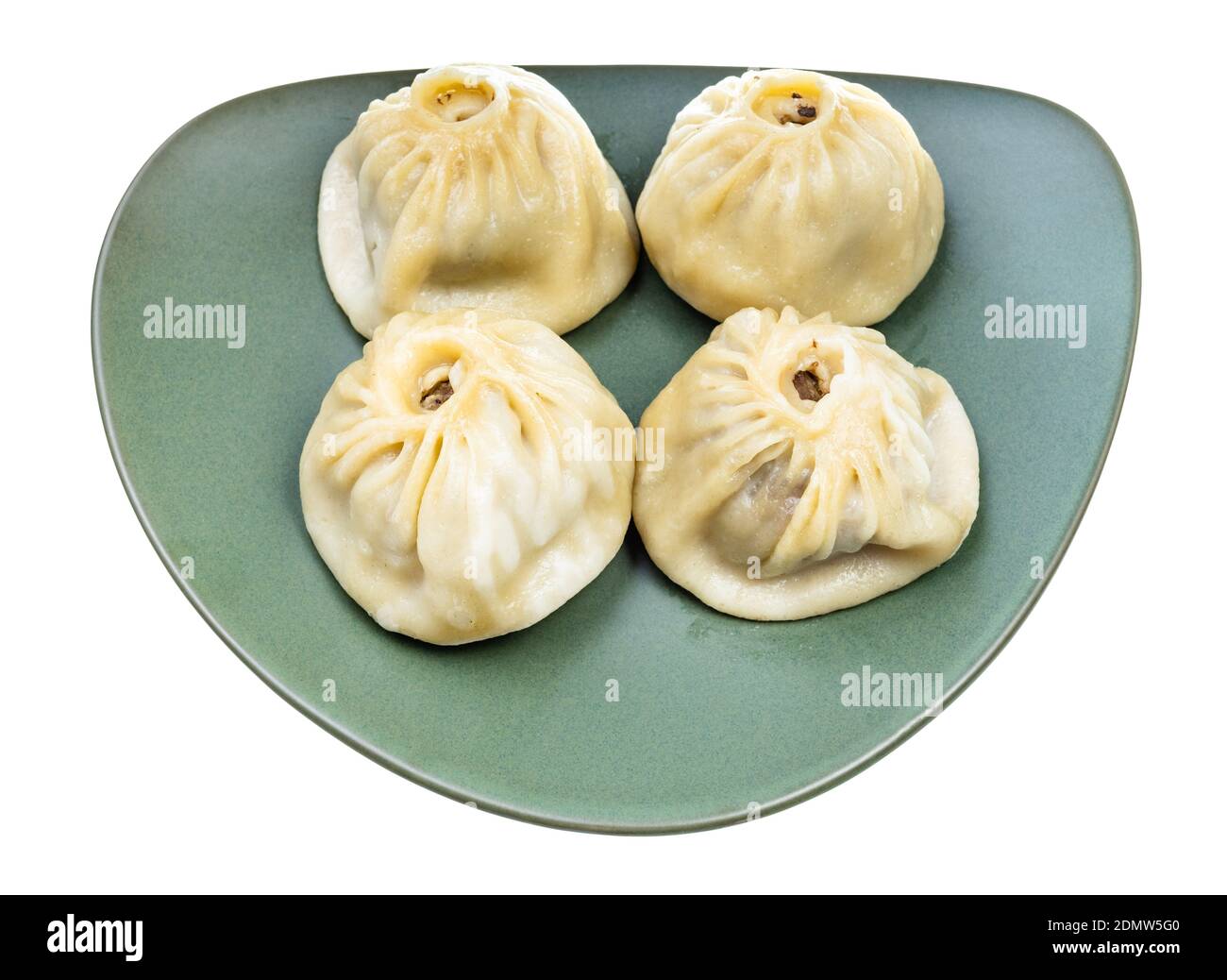 four steamed Buuz (Mongolian dumpling filled with minced meat) on green ...