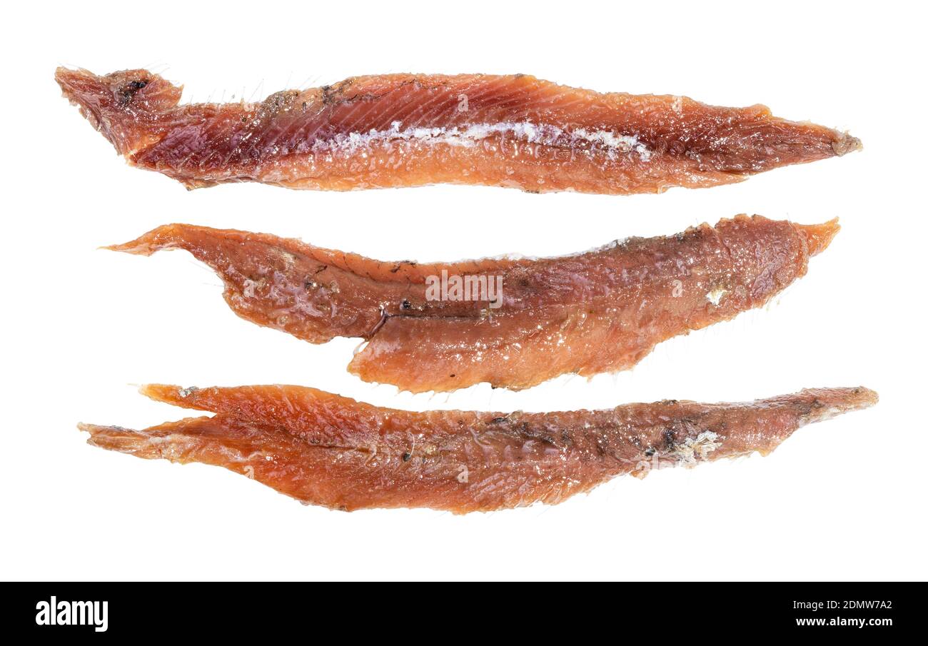 three single oiled anchovy fillets isolated on white background Stock ...