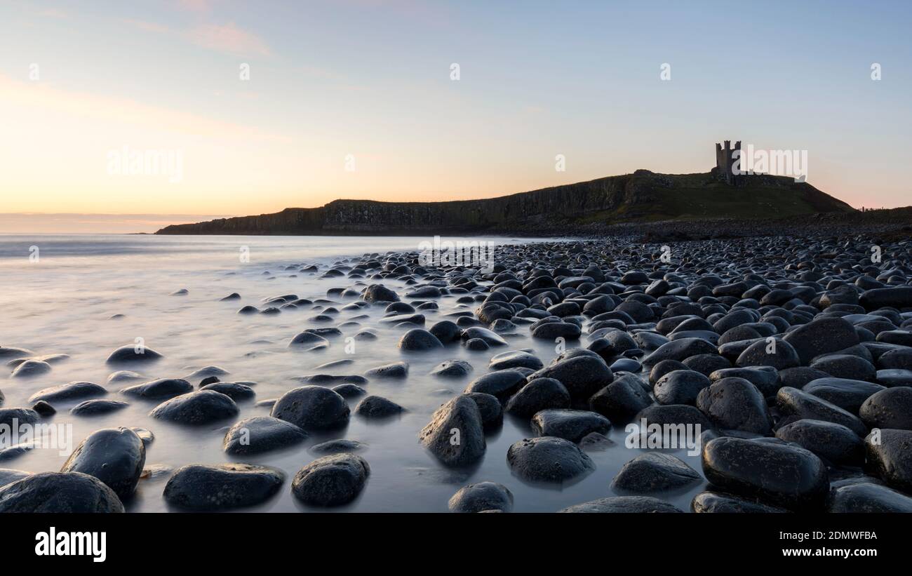 Sunrise, Dunstanburgh Castle from Embleton Bay, Northumberland coast ...