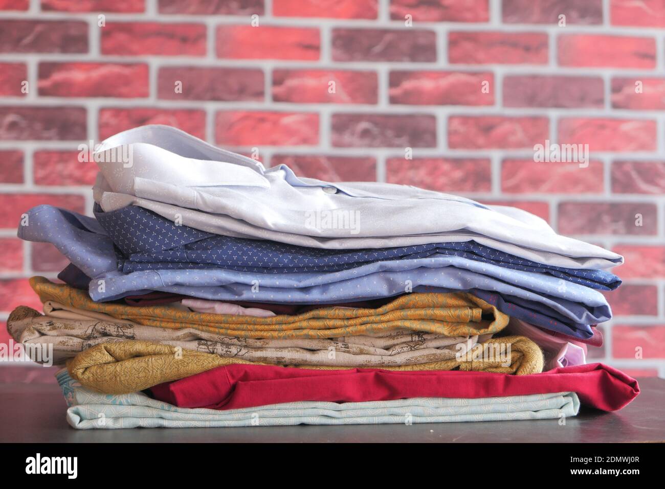 close up of stack of clothes on table Stock Photo - Alamy