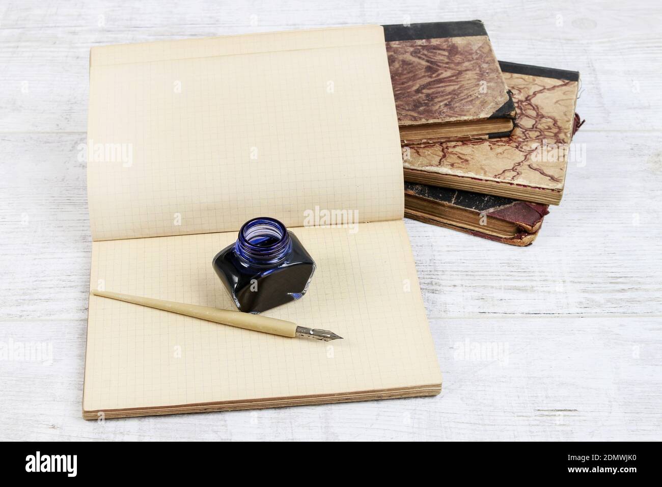 Inkwell, pen and an old notebook. Retro style Stock Photo - Alamy