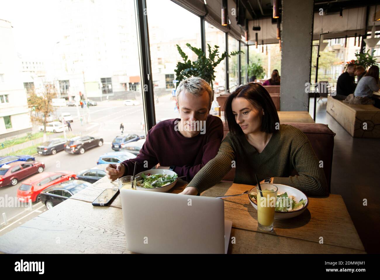 Couple spending time in restaurant together. Attractive young woman ...
