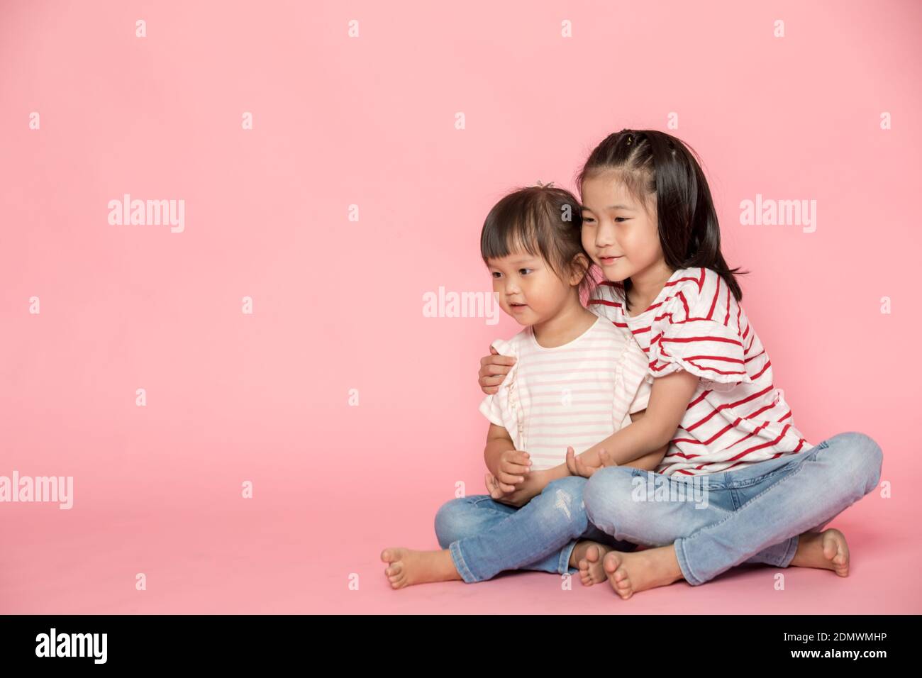 Sitting looking away smiling arm around hi-res stock photography and ...