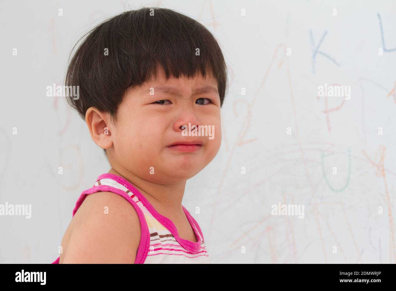 Girl crying against wall hi-res stock photography and images - Alamy