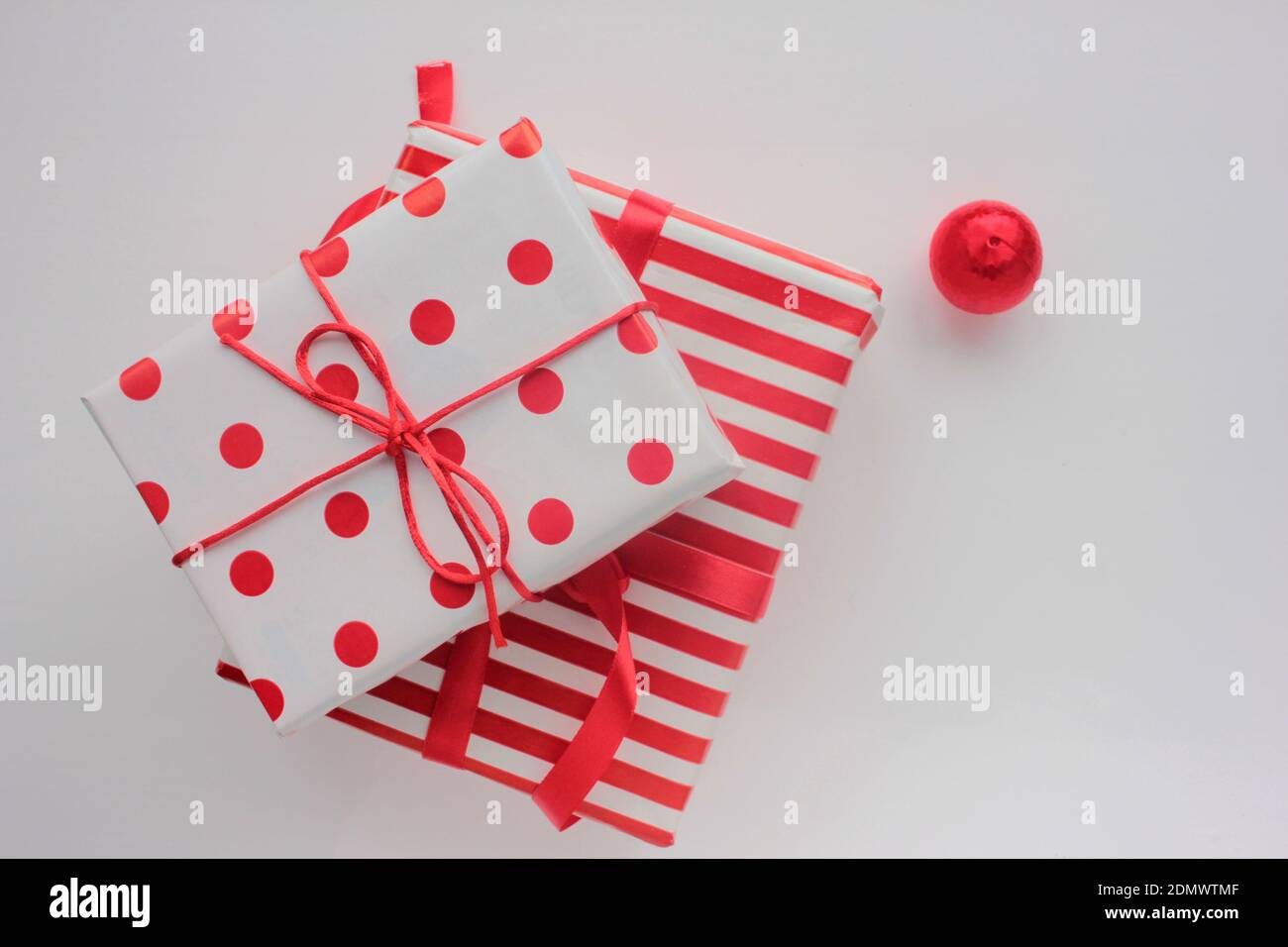 Gift box wrapped in red and white wrapping paper and tied with ribbon ...