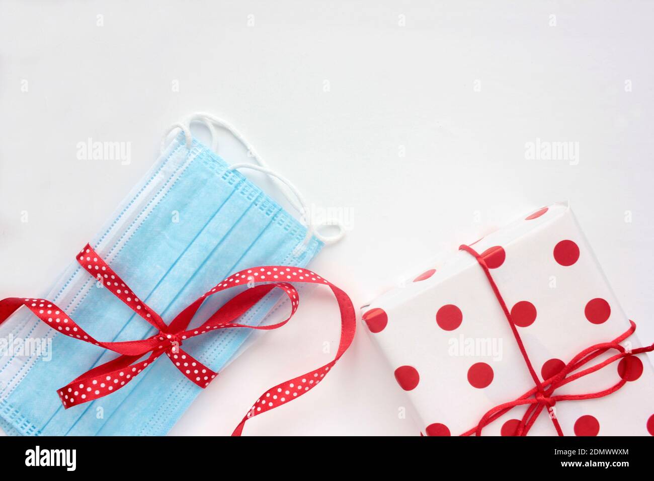 Disposable face masks and gift box on white background with copy space ...