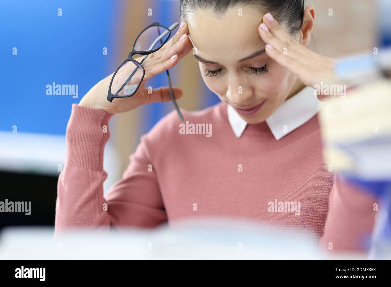Tired woman at the work table. irregular working hours Stock Photo - Alamy