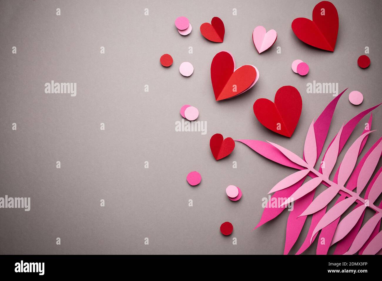 Red hearts cut from paper on pink background, paper craft origami style ...