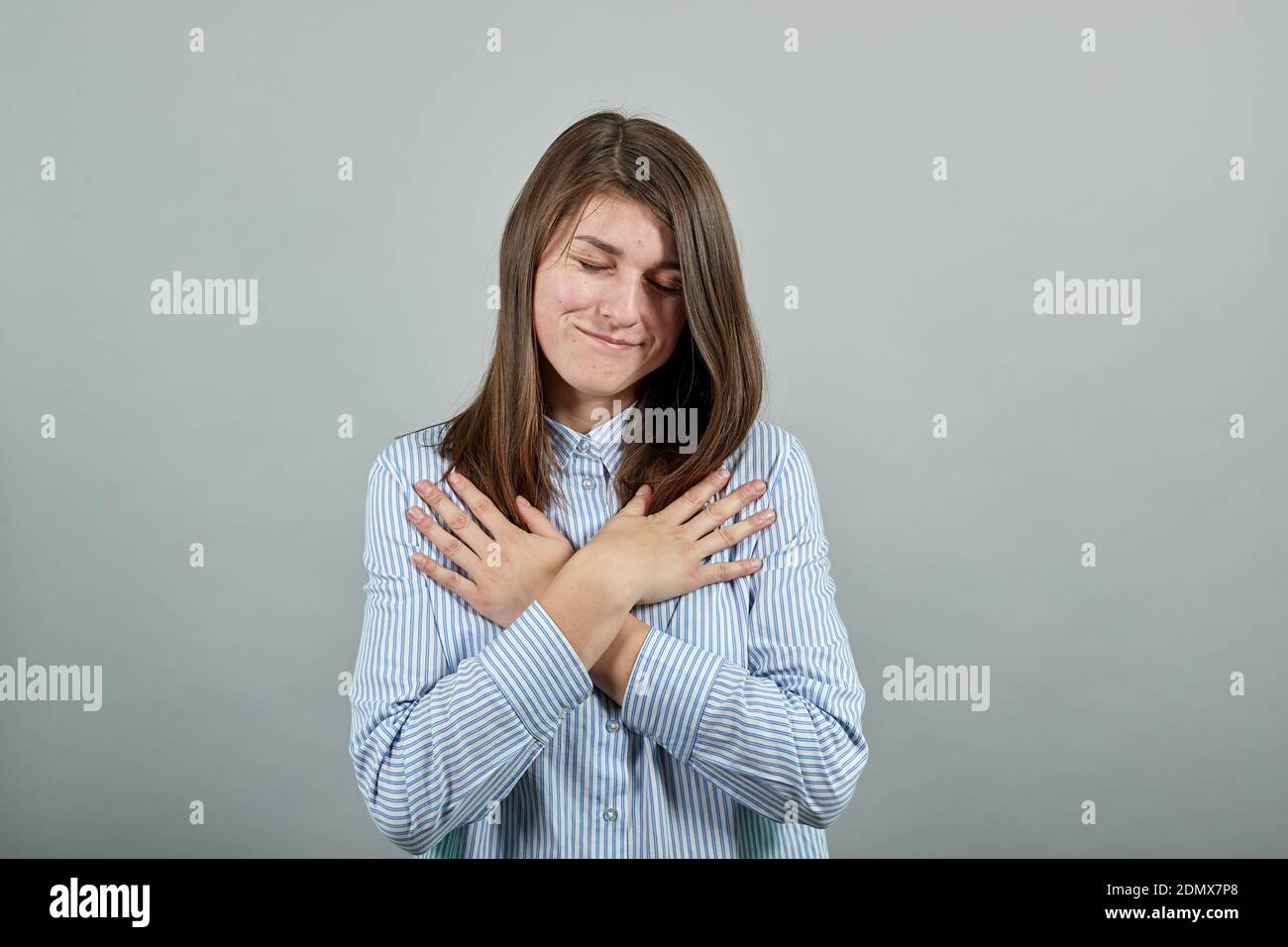 Woman hugging herself indoor hi-res stock photography and images - Alamy