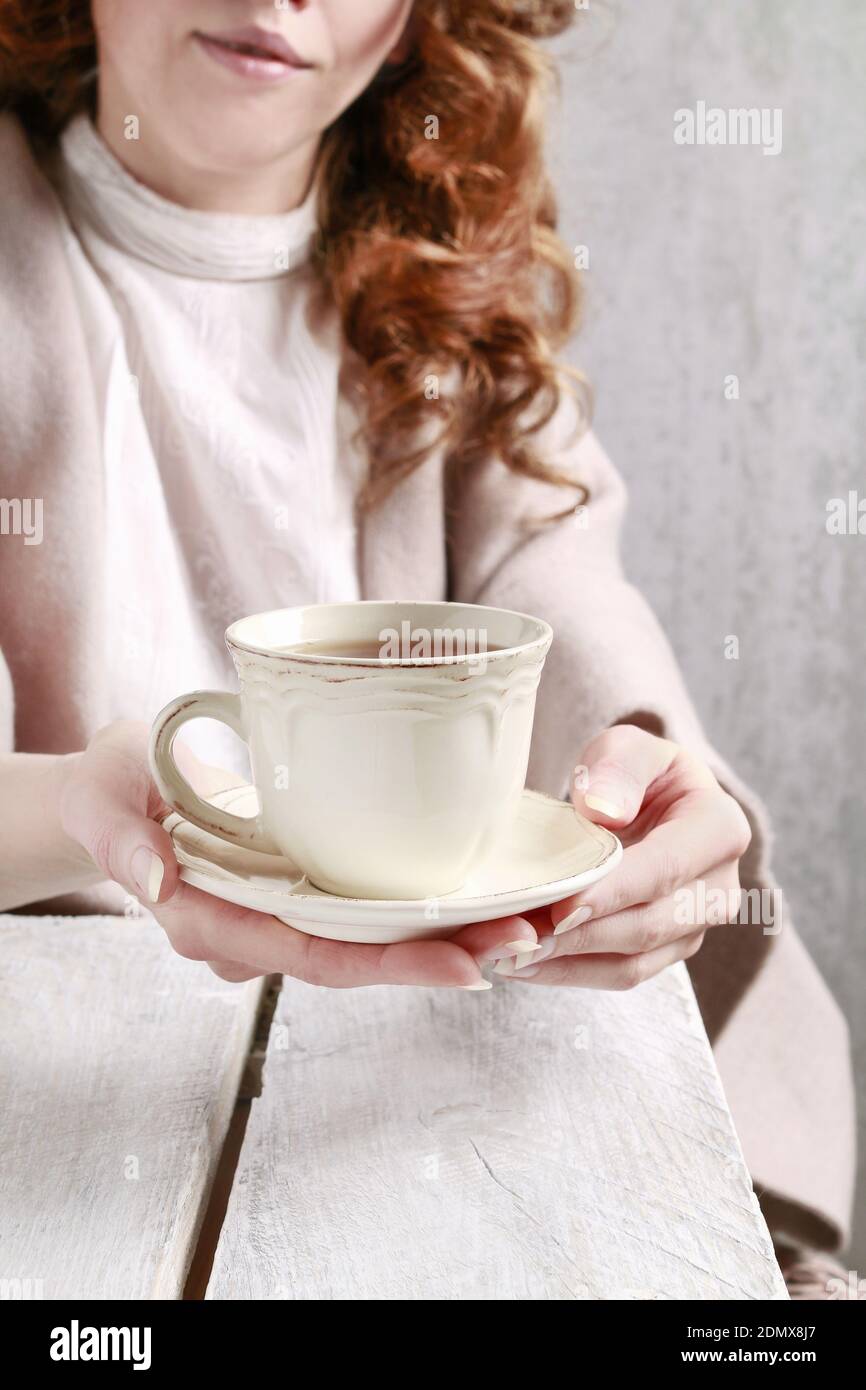 A woman is giving a cup of tea. Party time Stock Photo - Alamy