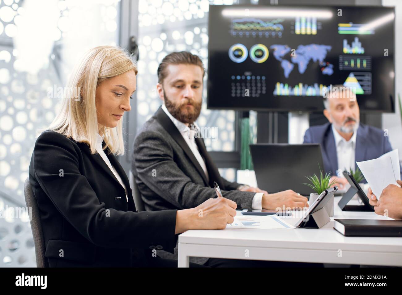 Smart focused businesspeople having meeting in boardroom at office in ...