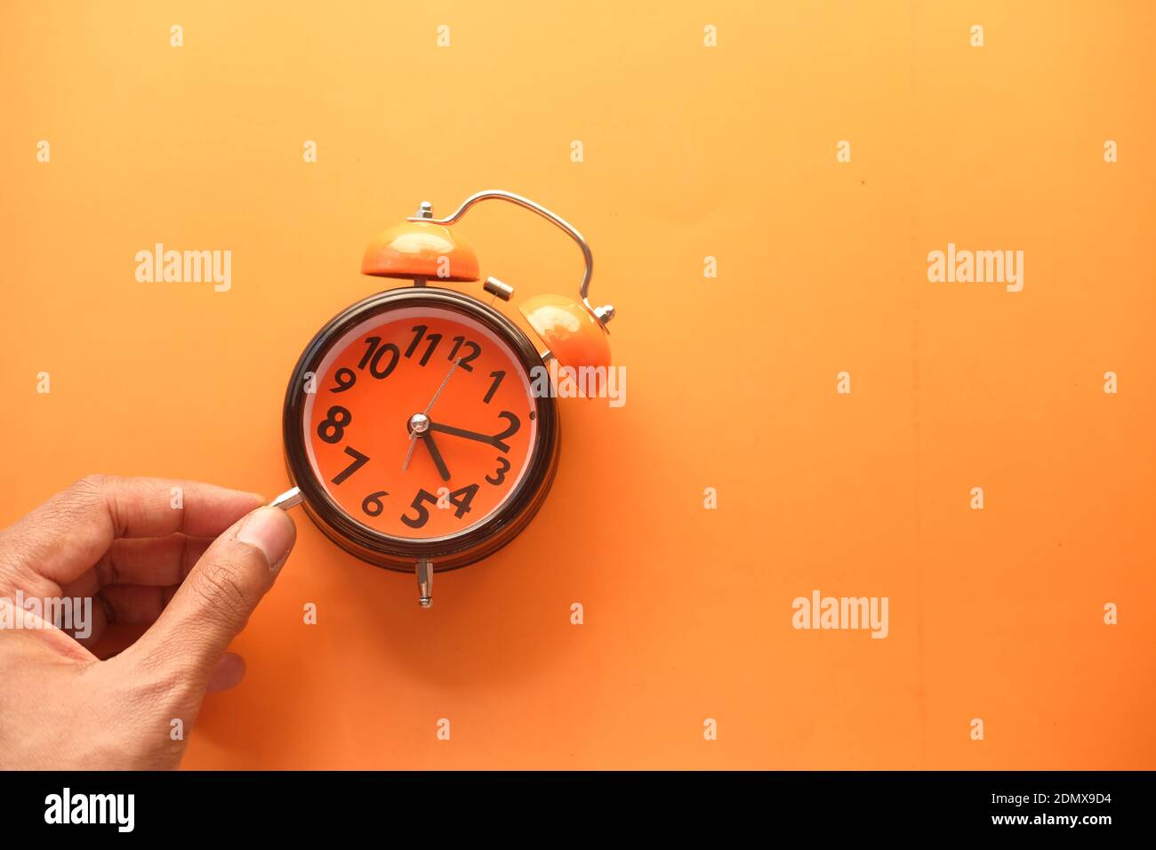A hand holding a watch Stock Photo - Alamy