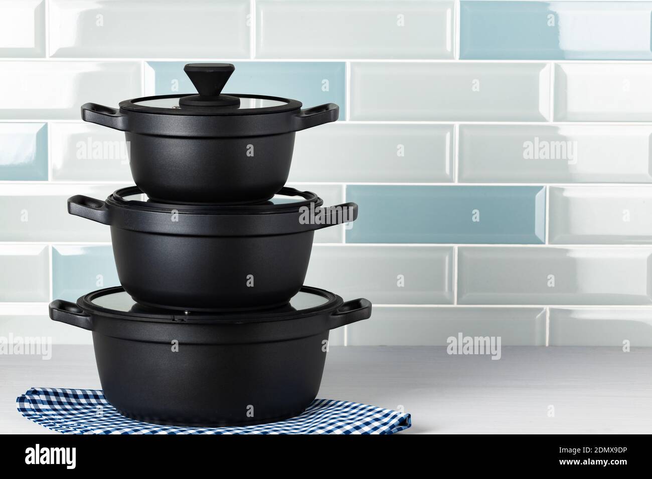 Set of black cookware on kitchen counter Stock Photo - Alamy