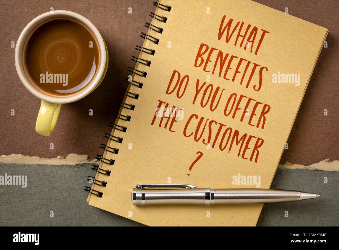 What benefits do you offer the customer? Handwriting in a notebook with ...