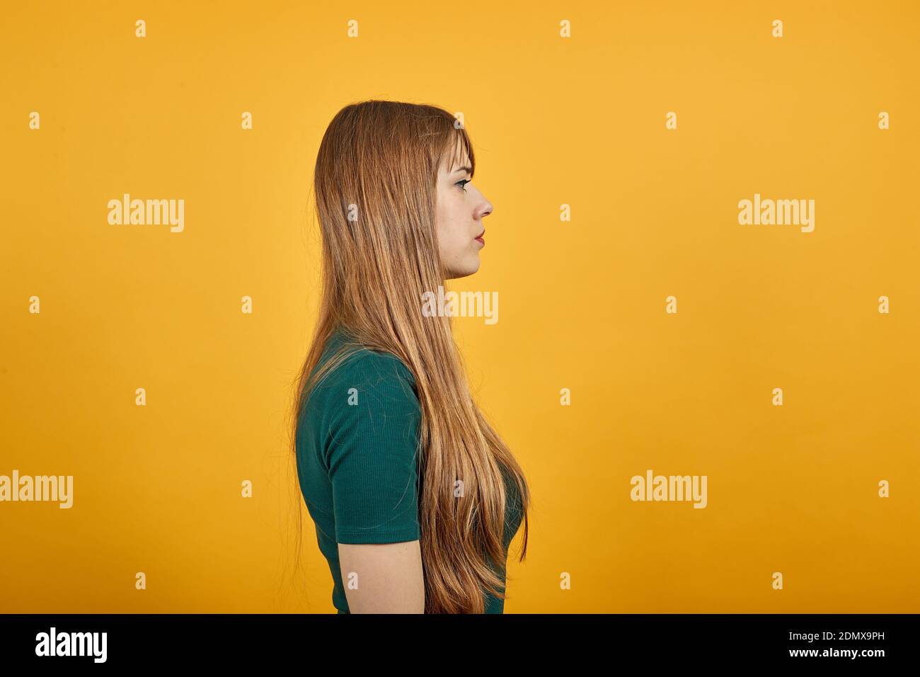 Side view of standing young beautiful watching. Rear view people ...