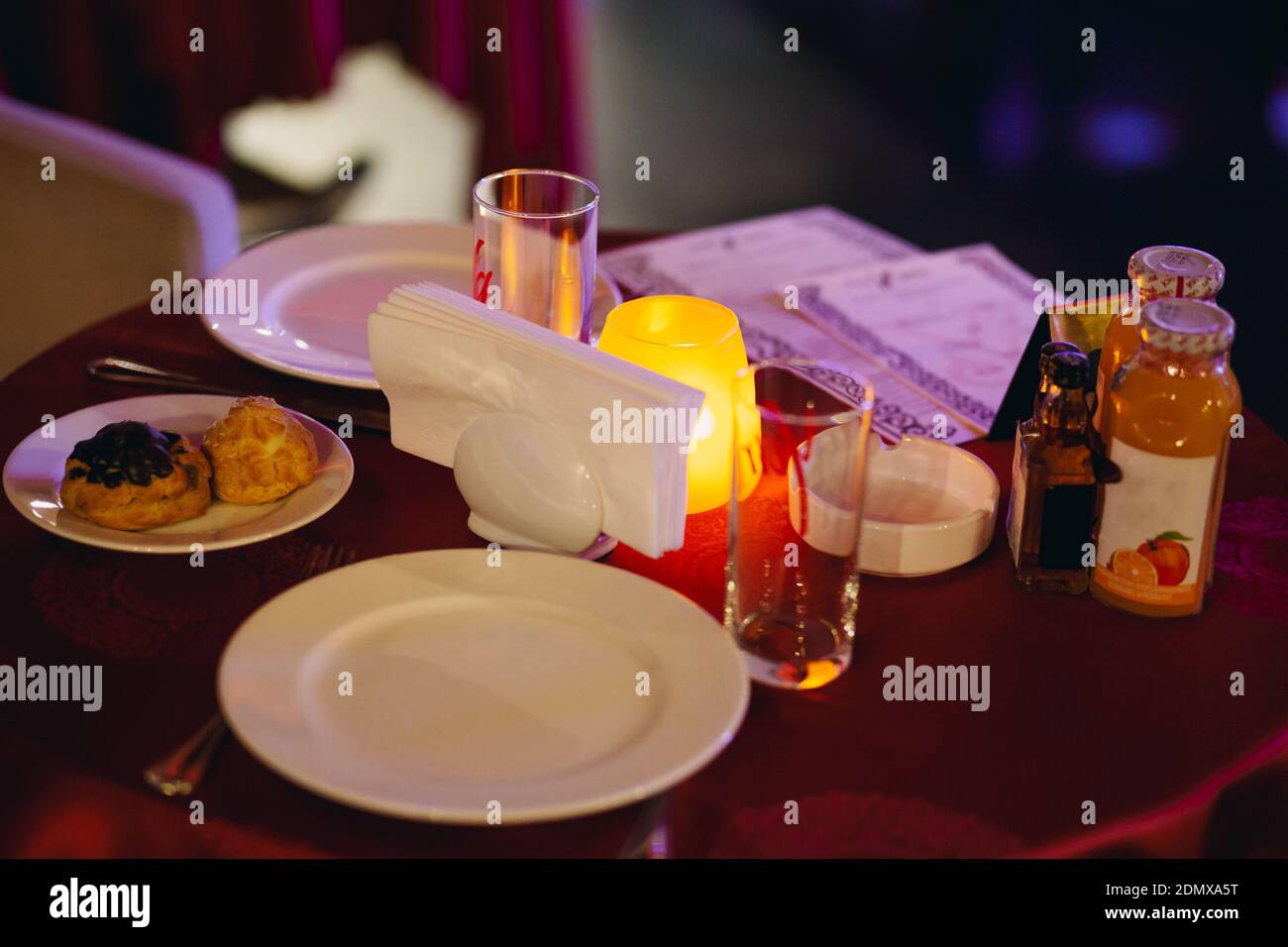 Simple restaurant table with natural juice and cream puffs Stock Photo ...