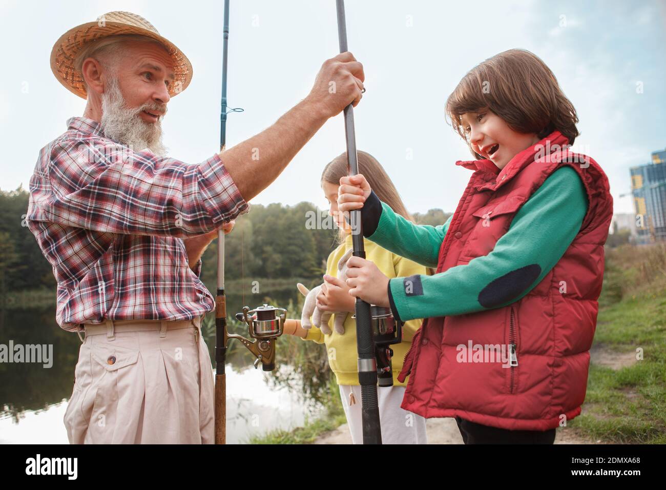 Happy young boy looking excited, receiving fishing rod from his ...