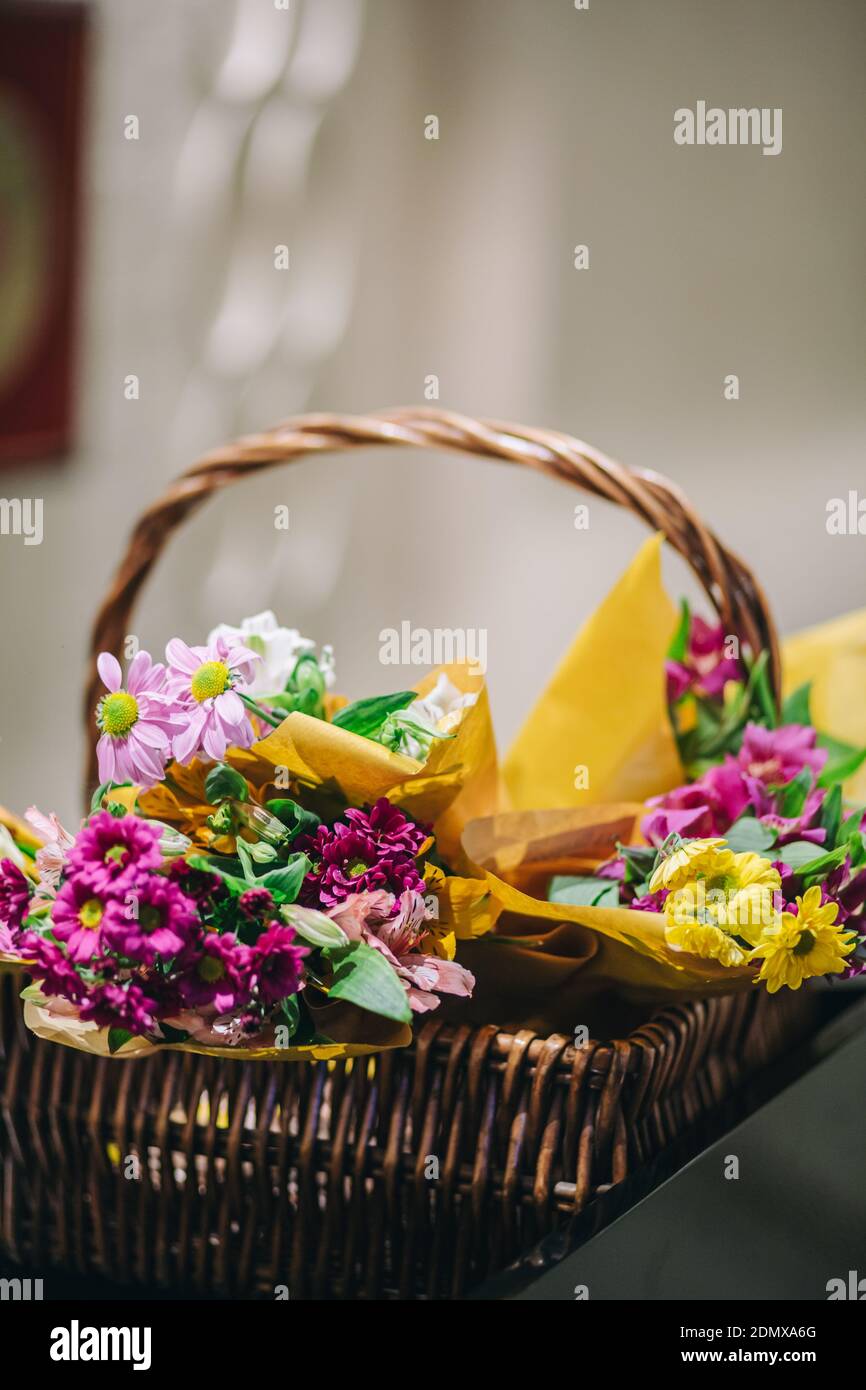 Thatch basket full of colorful flowers in cafe restaurant Stock Photo ...