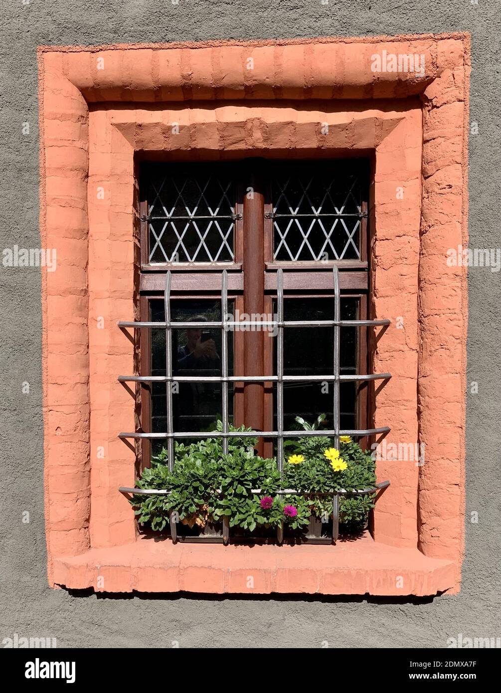 A vertical shot of caged window with orange frame Stock Photo - Alamy