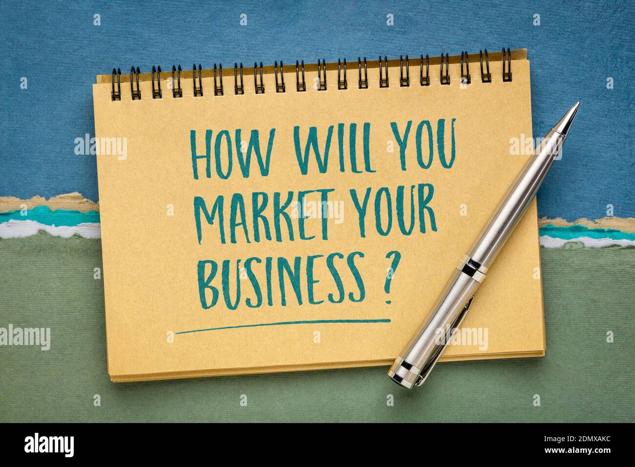 How will you market your business? Handwriting on a spiral notebook ...