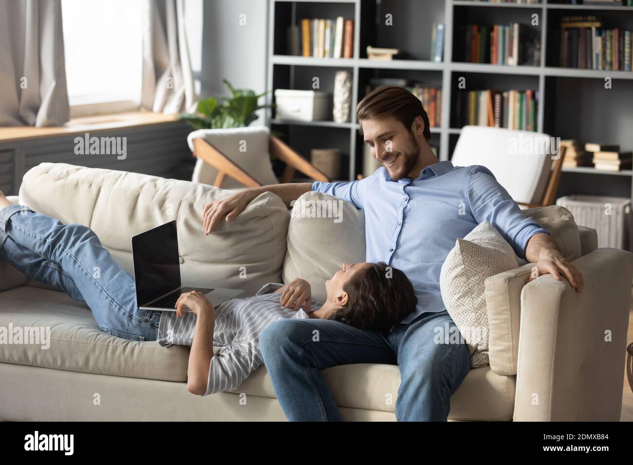Happy couple rest at home using computer Stock Photo - Alamy