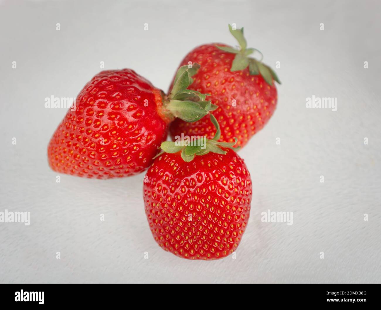 Three strawberries on white background hi-res stock photography and ...
