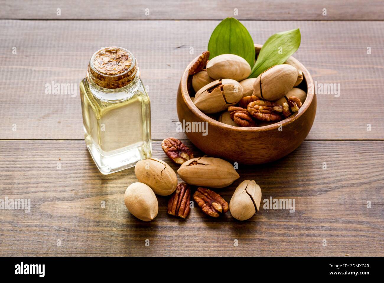 Pecan essential oil in bottle with nuts, close up Stock Photo - Alamy