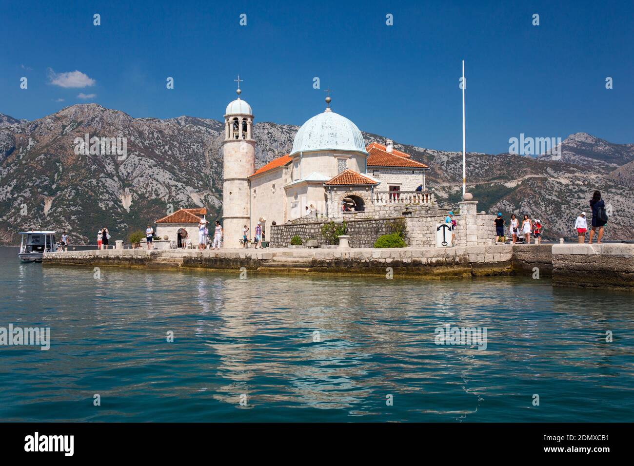 Perast, Kotor, Montenegro. View across tranquil water to the Church of ...